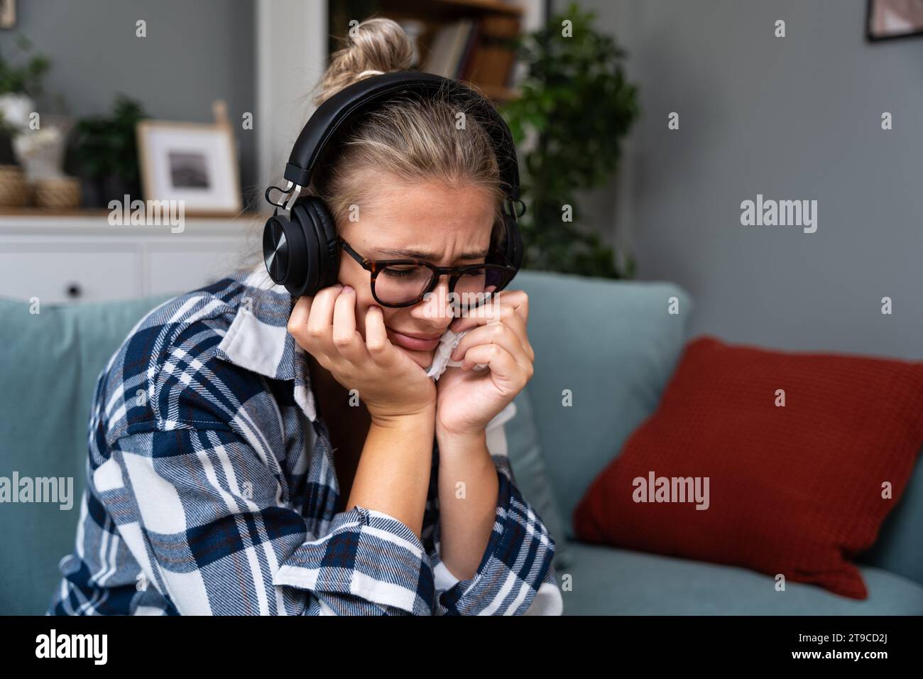 Sad tired young woman touching forehead having headache migraine or ...