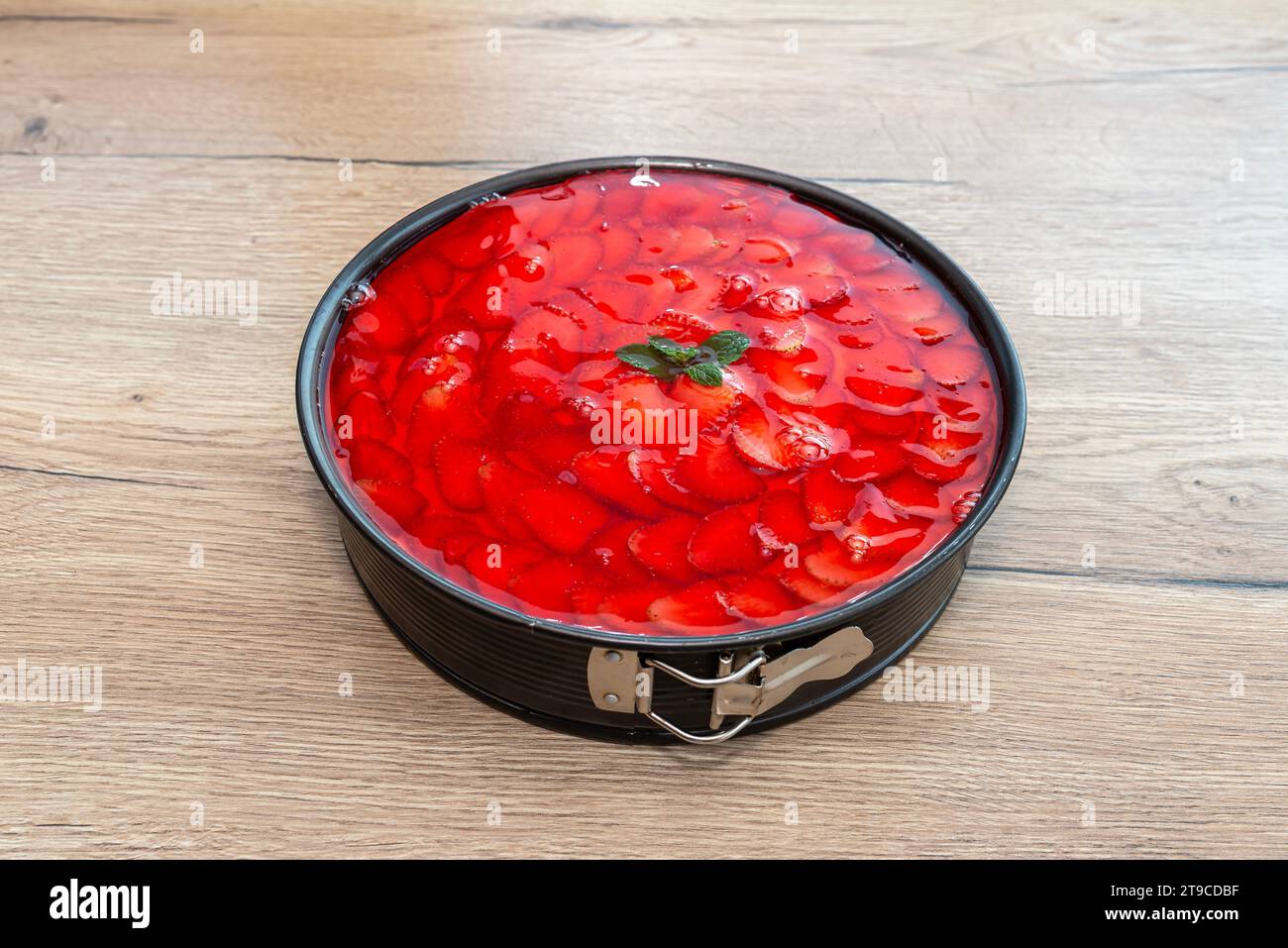 Sponge cake with custard cream and strawberries covered with jelly on ...