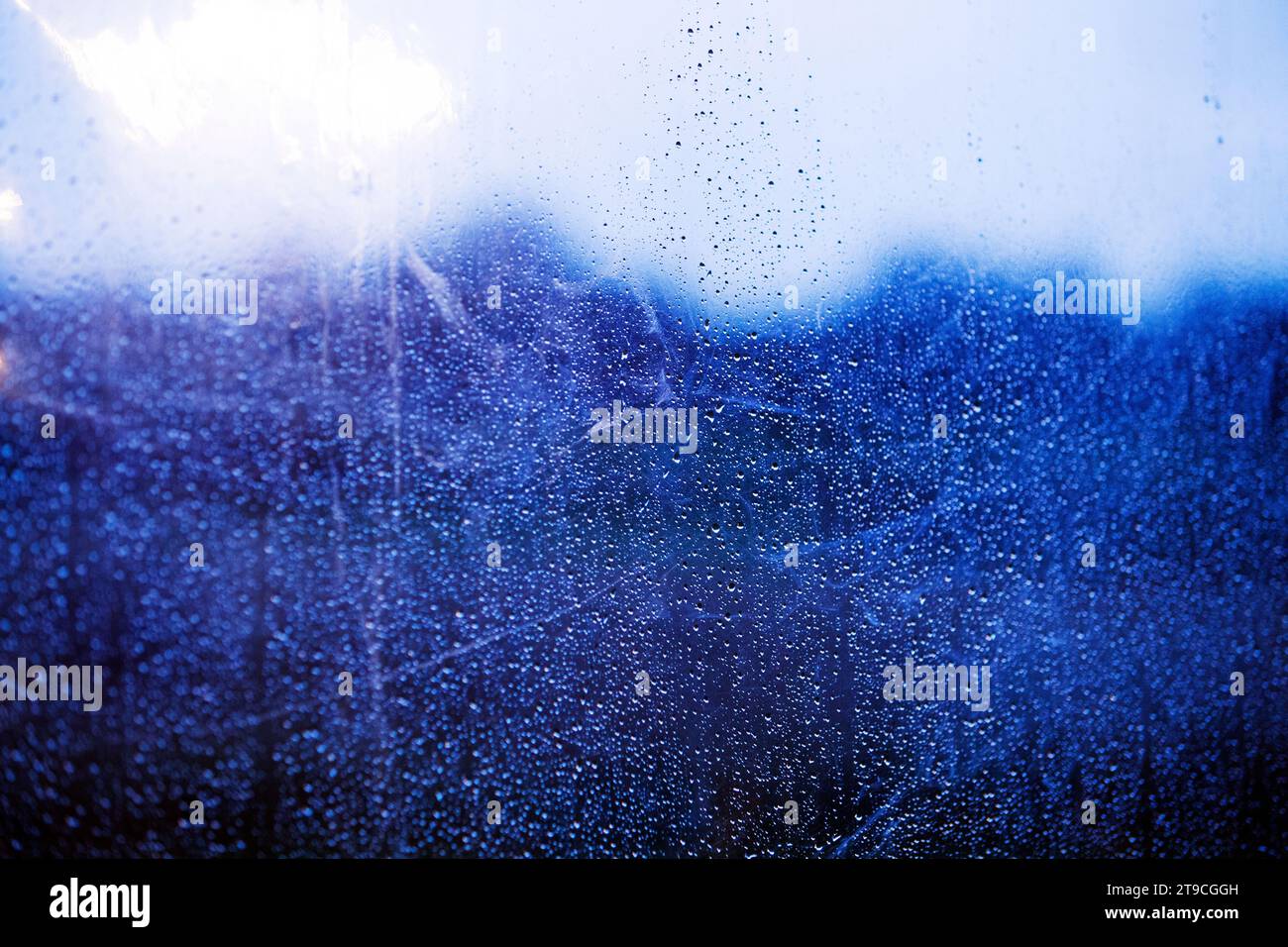 pattern of small raindrops against a clear blue toned surface Stock ...
