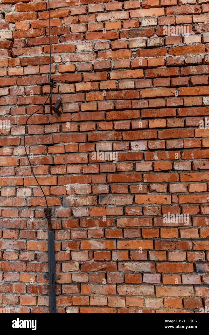 An old brick wall with a wire lightning rod installed Stock Photo - Alamy