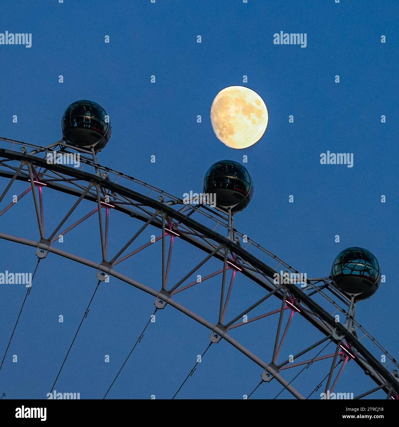 London, UK. 24th Nov, 2023. The Moon appears to dance atop capsules of ...