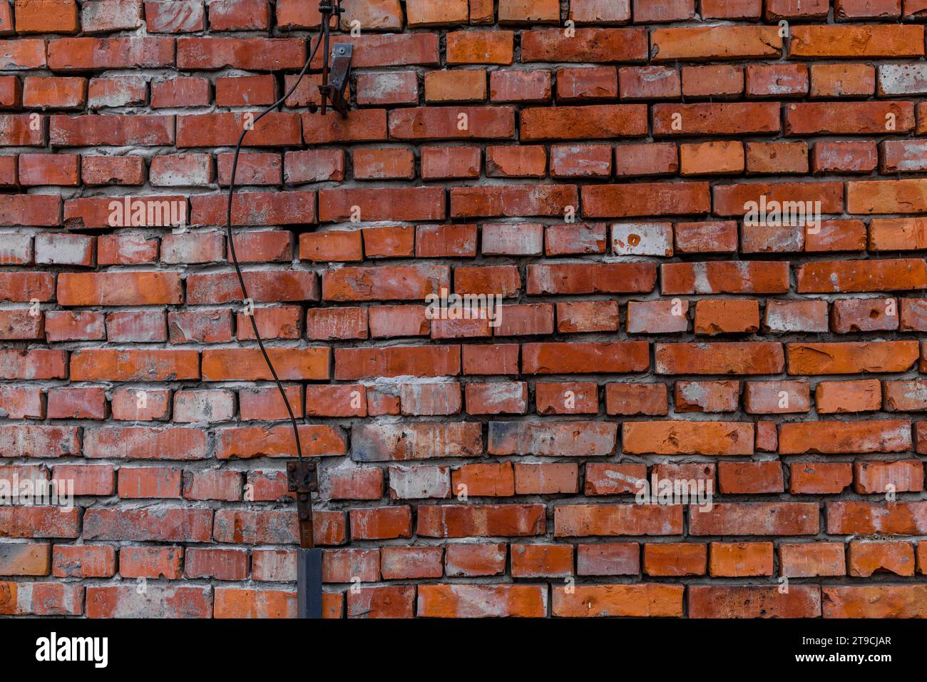 An old brick wall with a wire lightning rod installed Stock Photo - Alamy