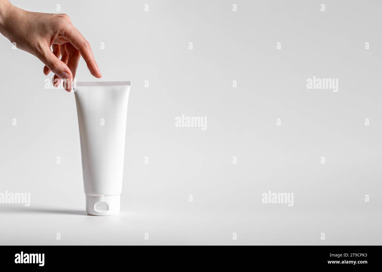 Cream tube mockup, hand touching cosmetic product, beauty package mock ...