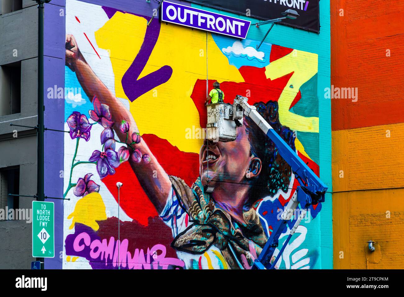 Street art in Detroit. A worker in a pallet truck looks like a three ...