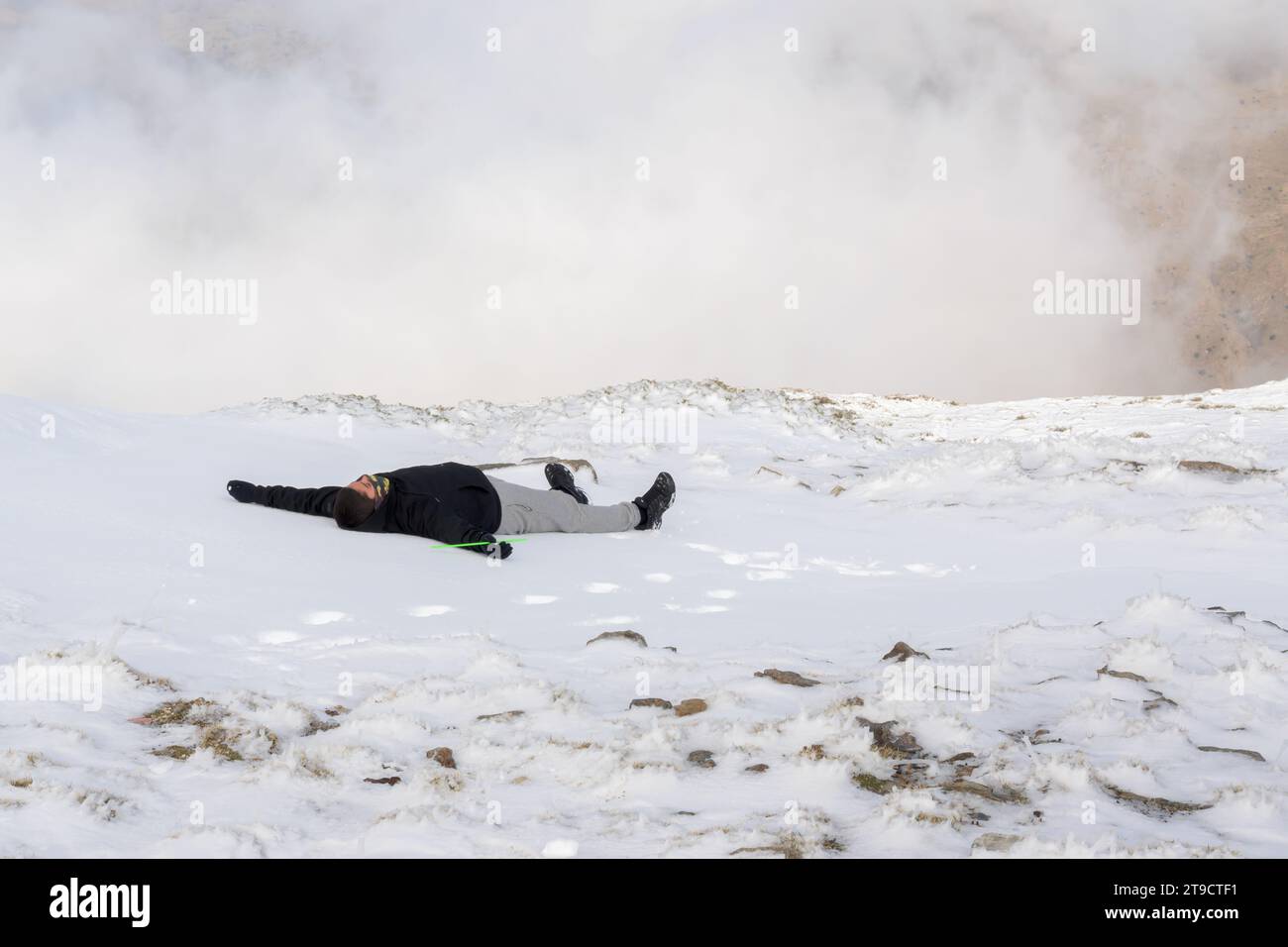 young Latin boy, lying in the snow, in the middle of a blizzard Stock ...