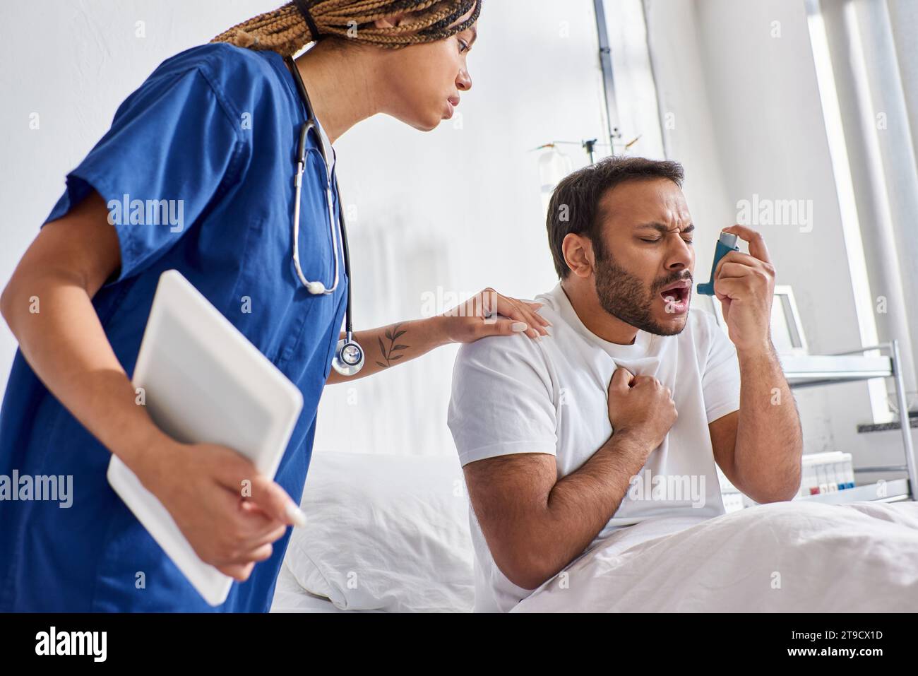 african american nurse helping her indian patient with asthma inhaler ...