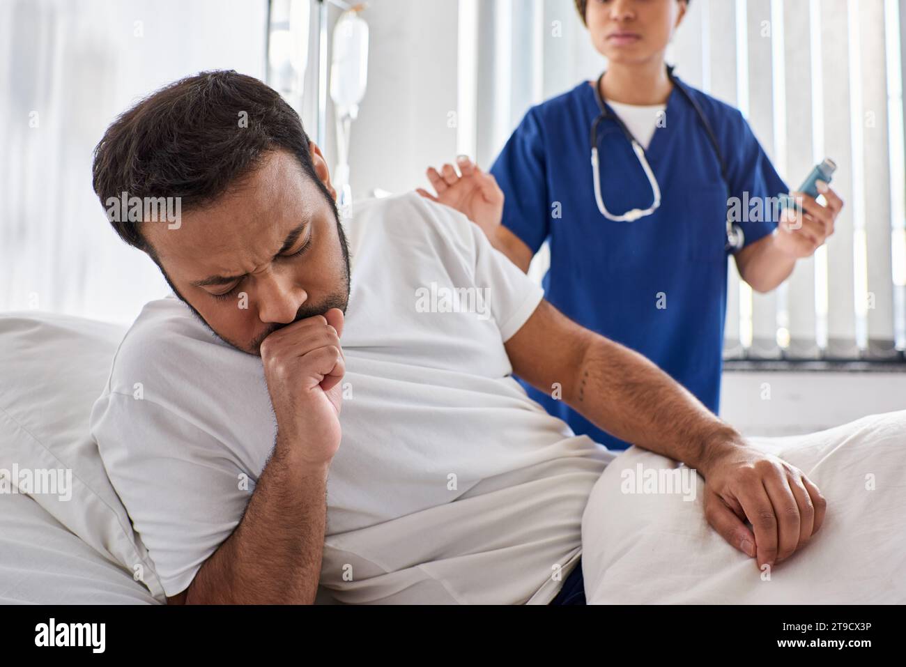 young african american nurse giving asthma inhaler to her ill indian ...