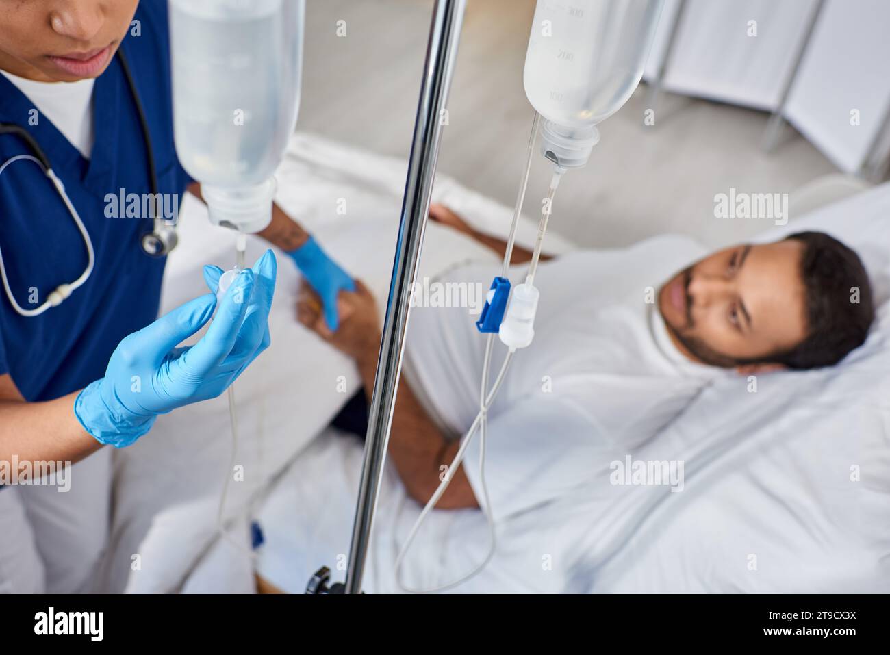 focus on african american nurse setting drop counter next to blurred ...