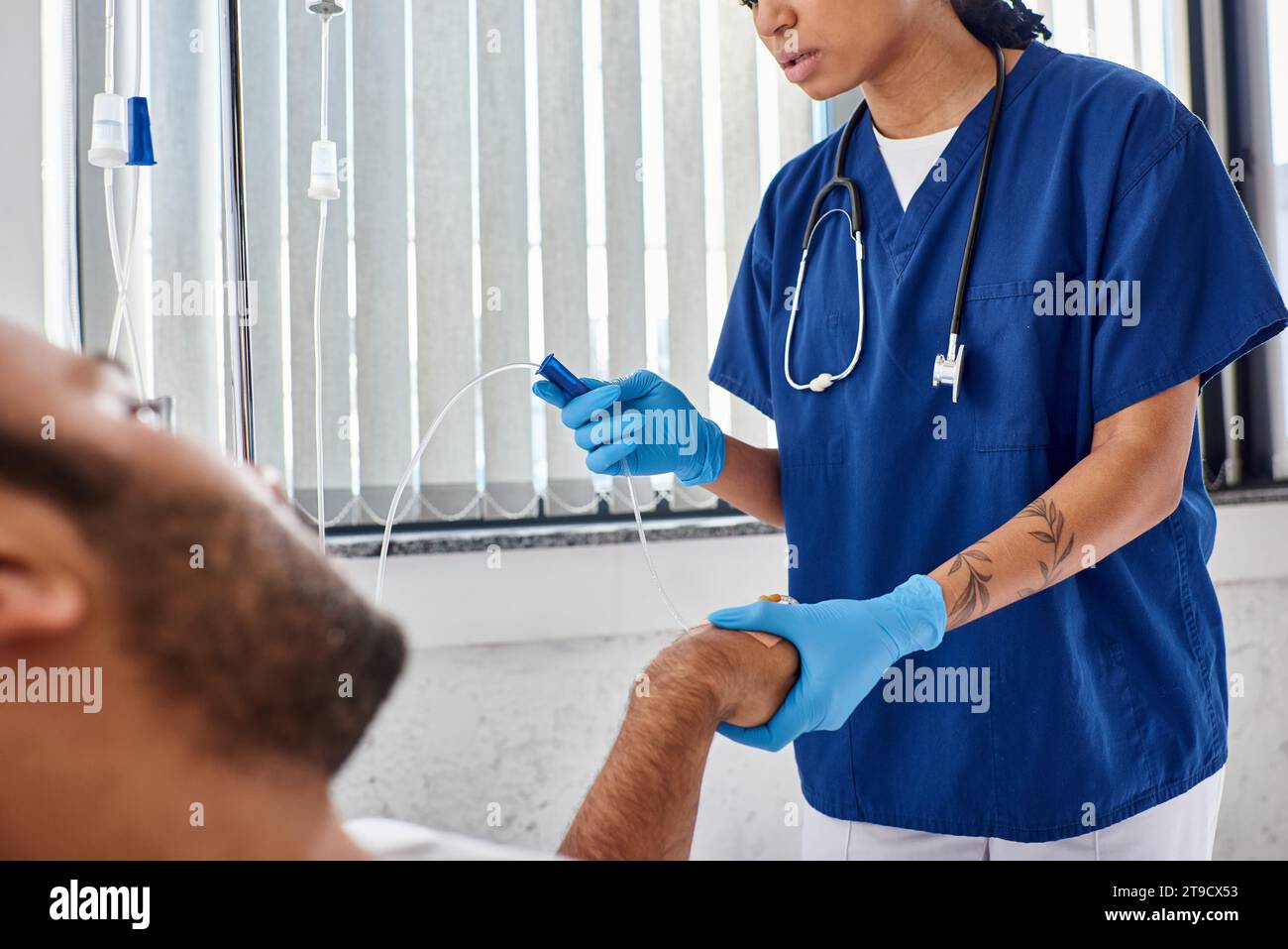 focus on african american nurse setting drop counter next to her ...
