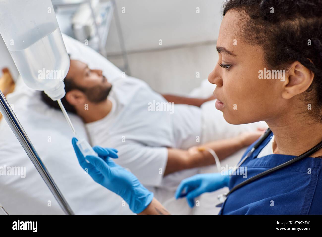 focus on african american nurse setting drop counter next to her ...