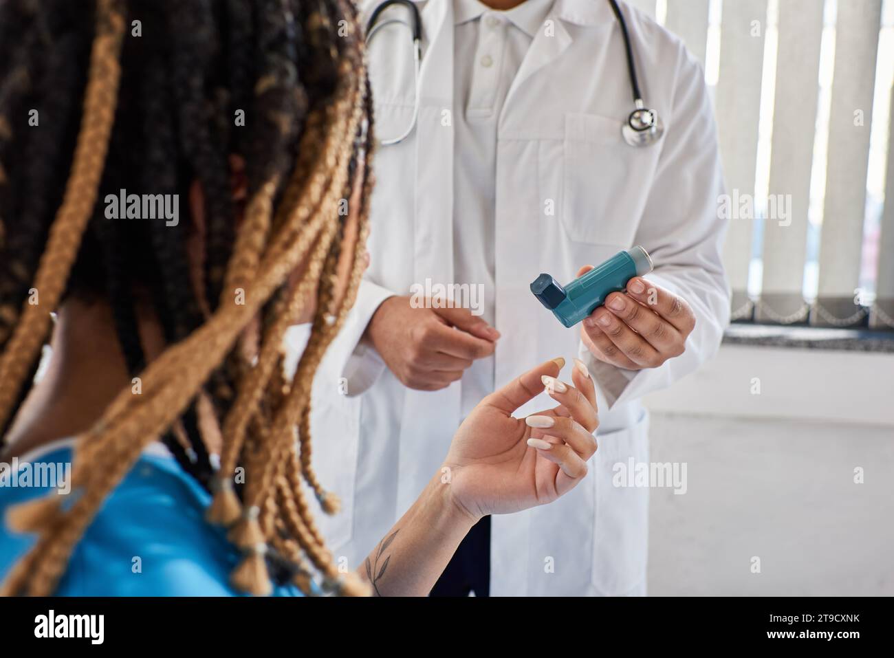 young indian doctor teaching his ill african american female patient ...