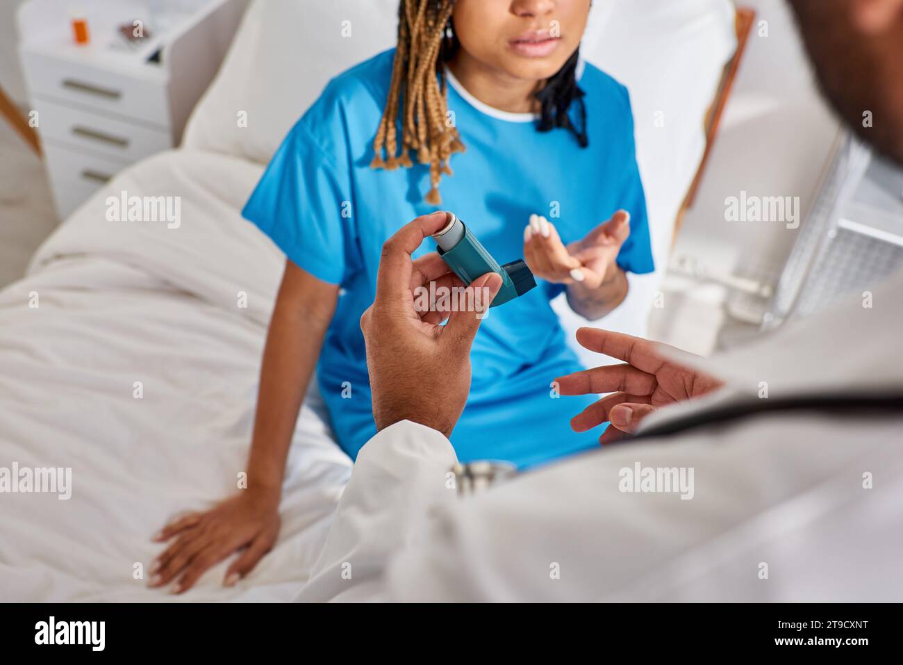 young indian doctor teaching his ill african american female patient ...