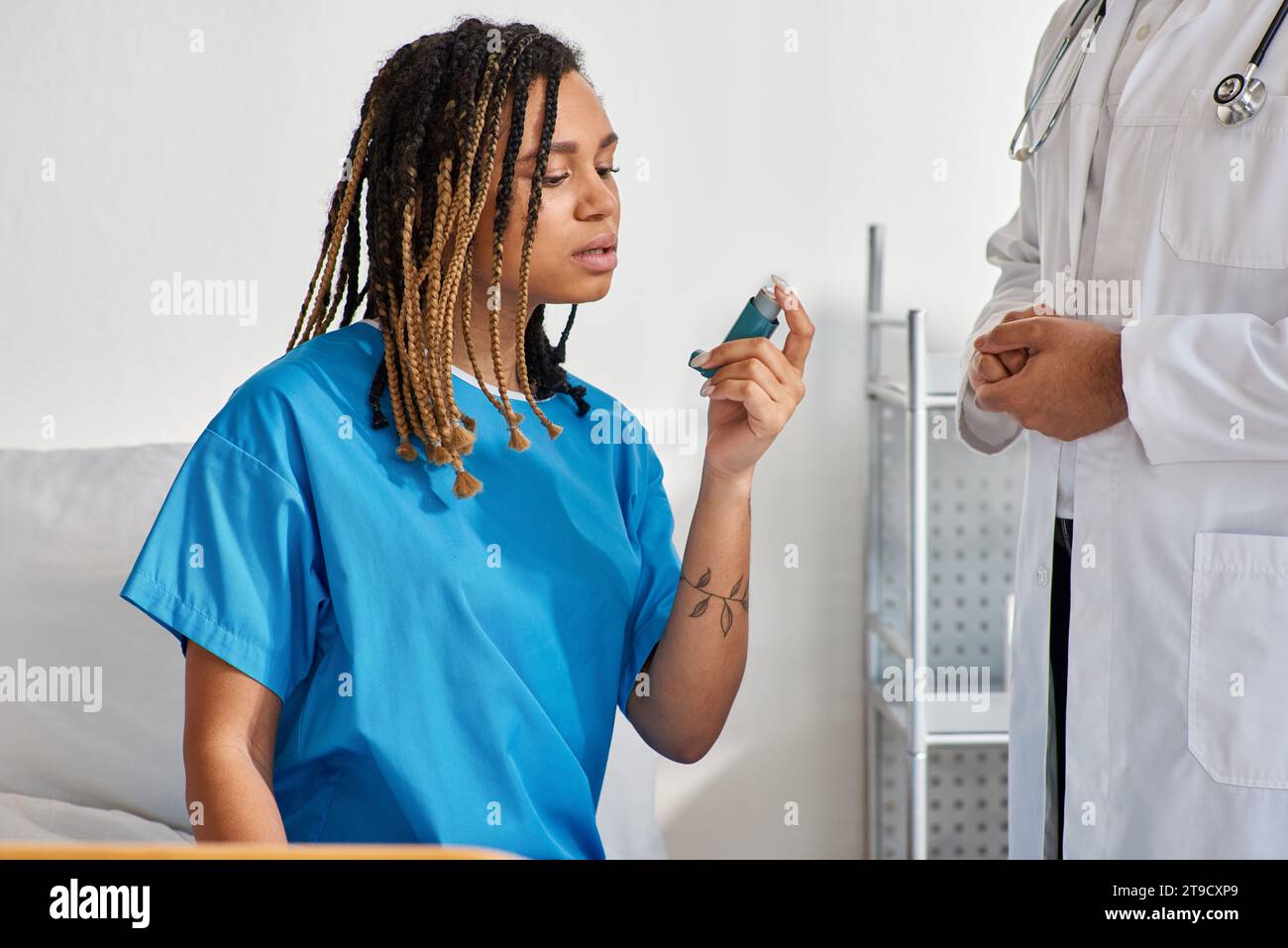 young indian doctor teaching his ill african american female patient ...