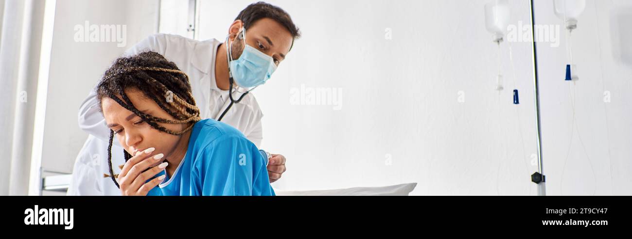 young indian doctor examining breath of his ill african american ...