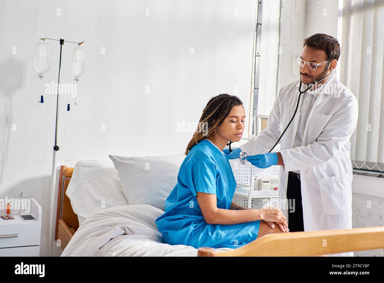 indian doctor checking breath of his african american female patient in ...