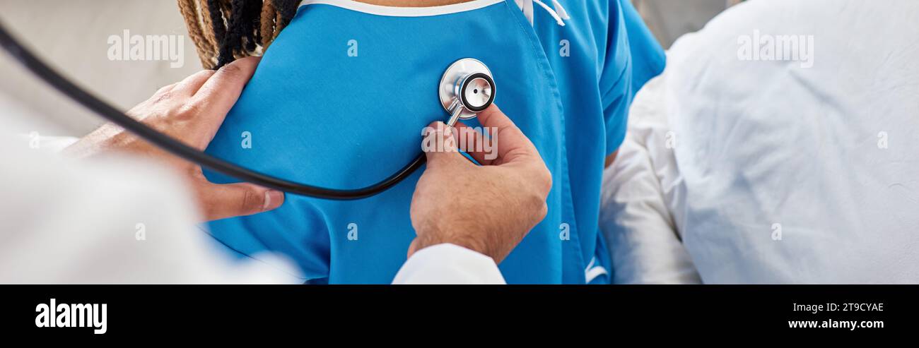 back view of indian doctor checking breath of his african american ...