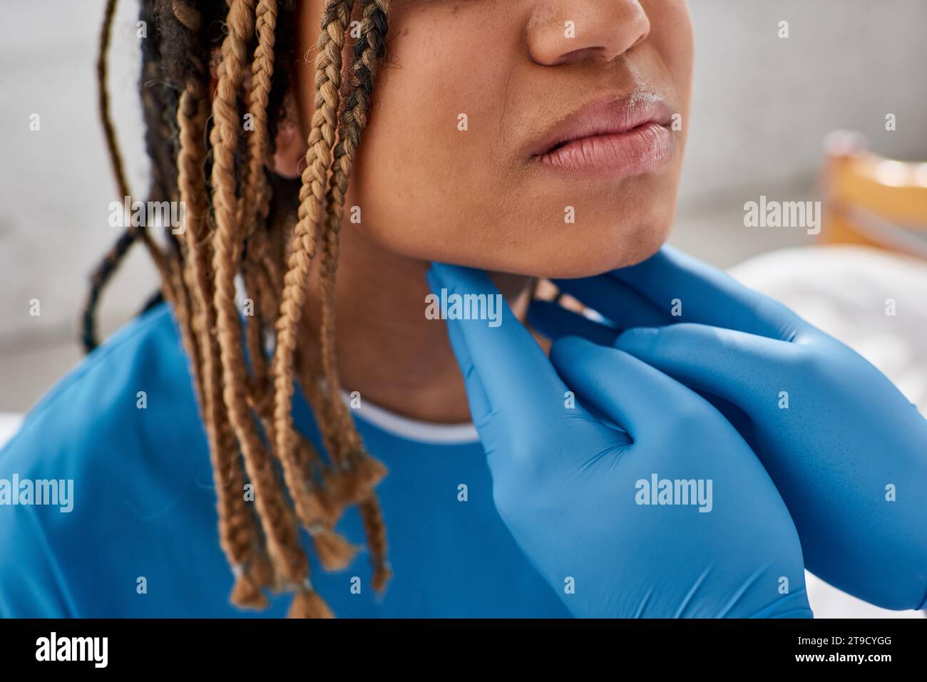 cropped view of indian doctor examining lymph nodes of his ill african ...