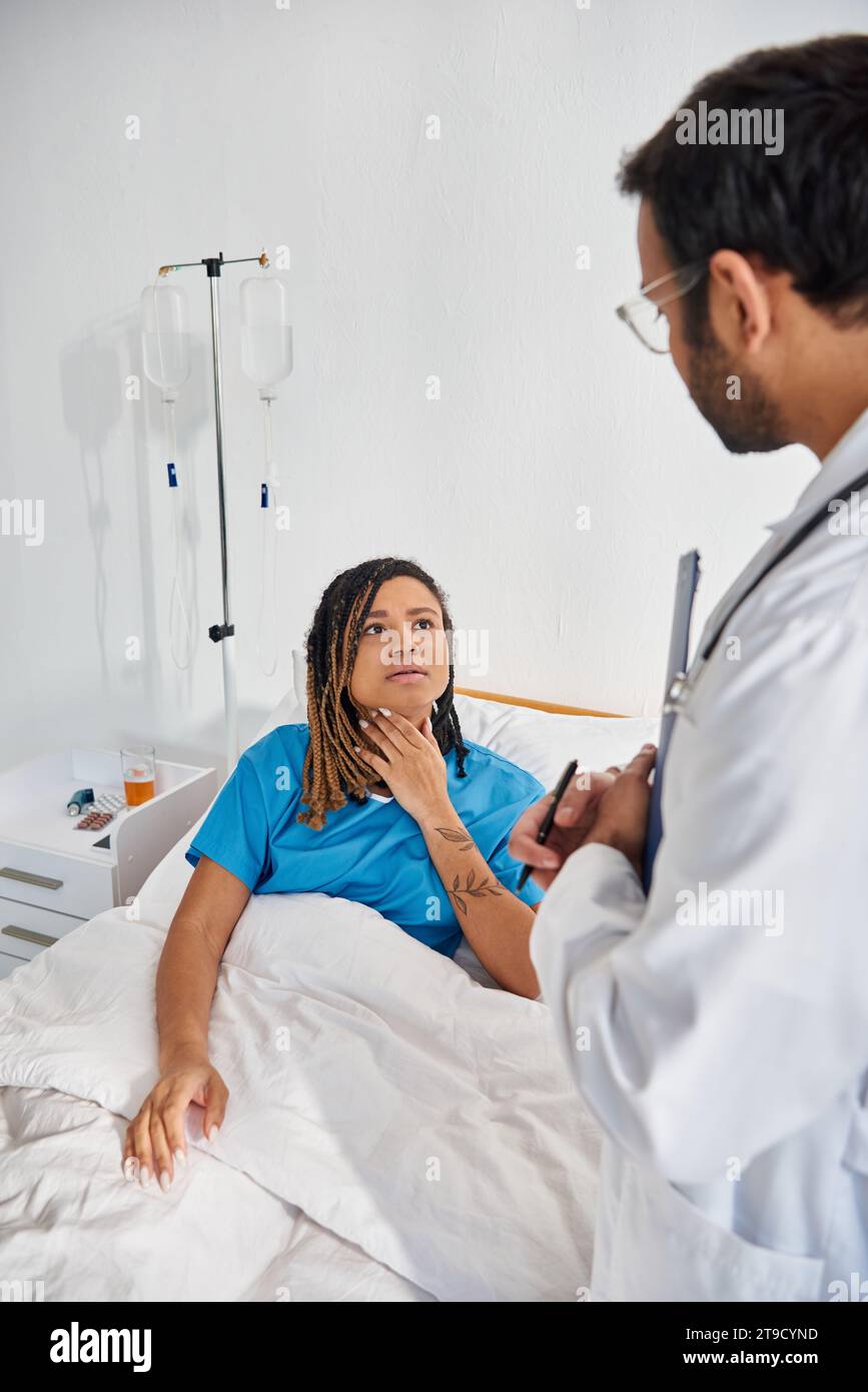 attractive african american woman lying in bed in hospital ward talking ...
