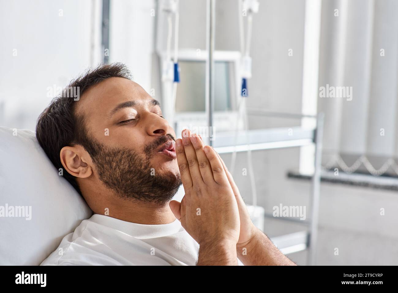 young happy indian patient cheering and gesturing actively while in ...