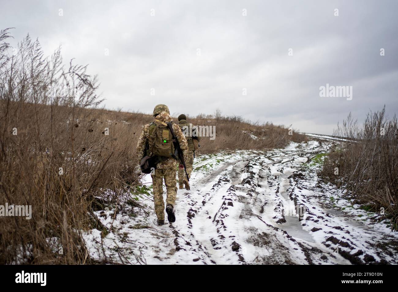 Two officers of Ukraine's state border guard walk to their positions in ...