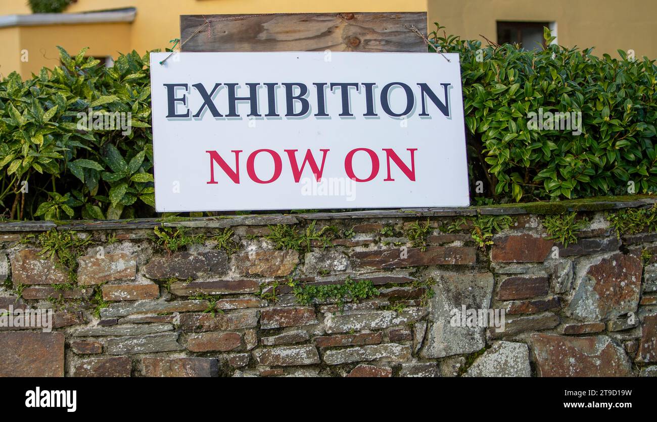 Exhibition sign on dry stone wall Black and Red on White letters Stock ...
