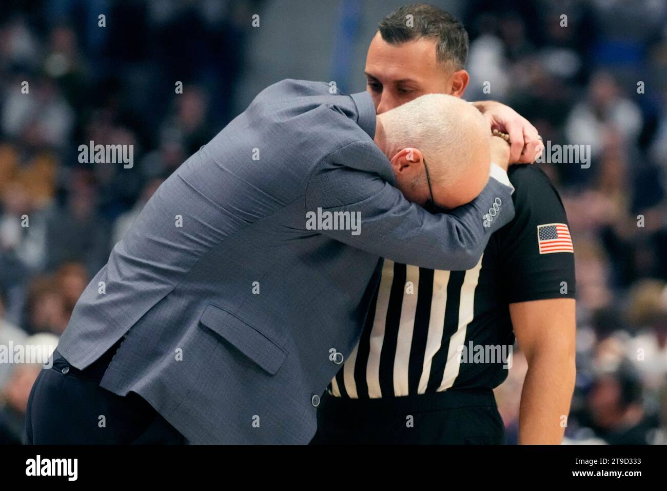 UConn head coach Dan Hurley embraces referee Mike Palau during a ...
