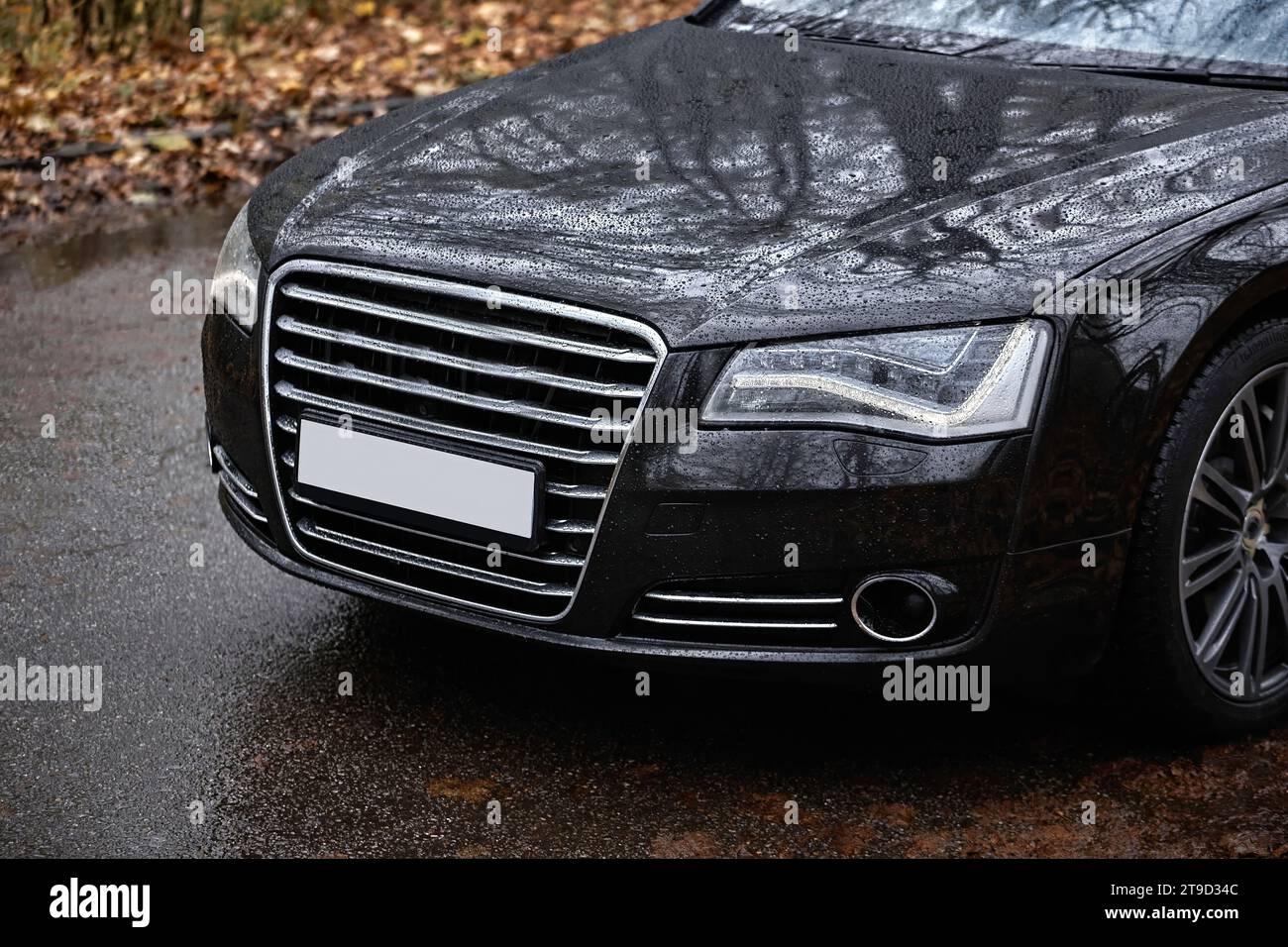 Modern black car driving on the road, city car background Stock Photo ...