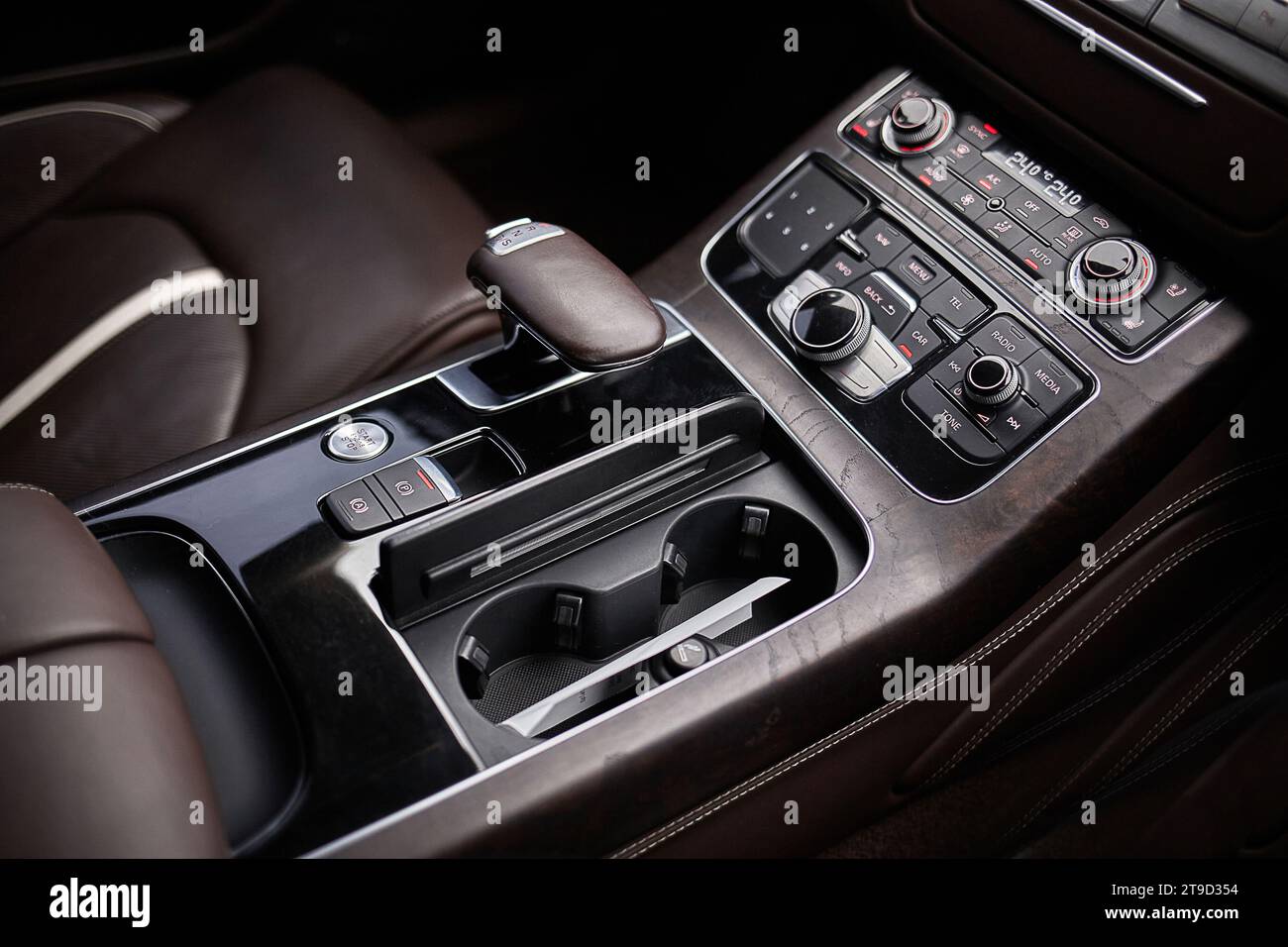 Shift lever, car steering wheel and sensors. Inside a modern car view ...