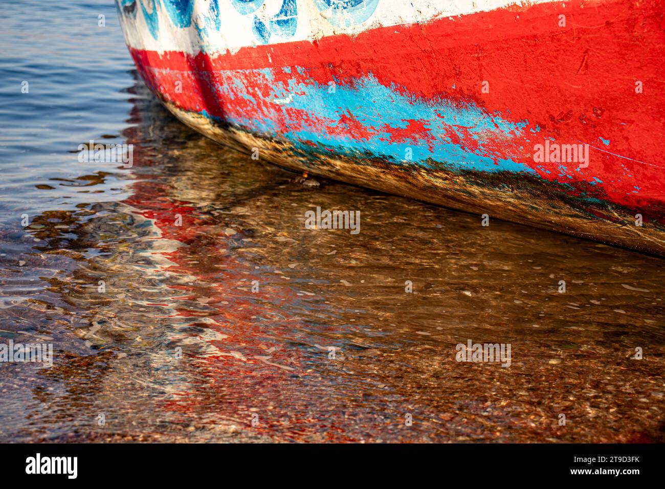 old rustic ship paint on seaside with water reflection Stock Photo - Alamy