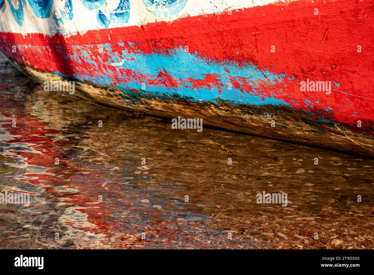 old rustic ship paint on seaside with water reflection Stock Photo - Alamy