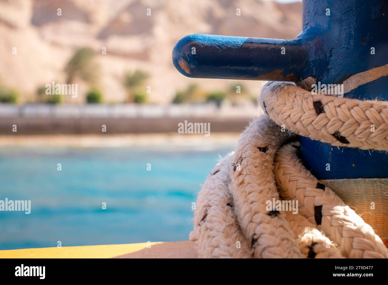 Bollards on ship with ropes at the sea in the background used for ...