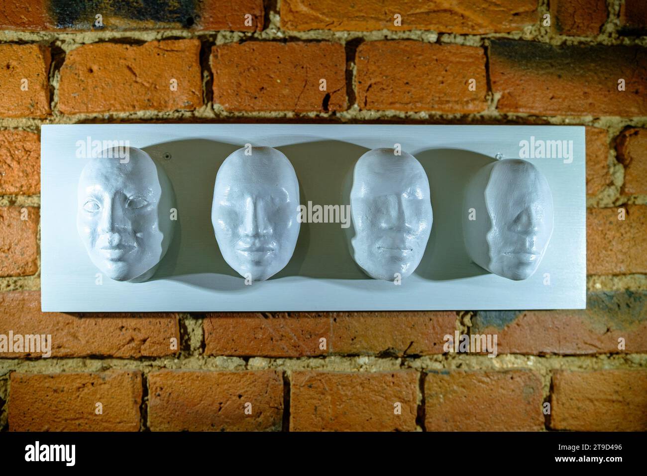 white mannequin head, Faceless, red brick wall and white wood floor ...