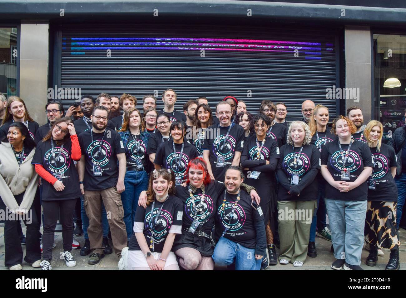 London, UK. 24th November 2023. HMV staff pose for a photo as the ...
