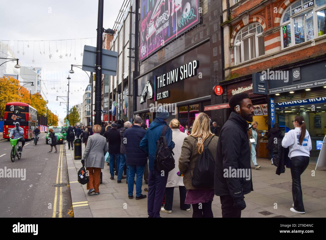 London, UK. 24th November 2023. Fans queue up for the reopening of HMV ...