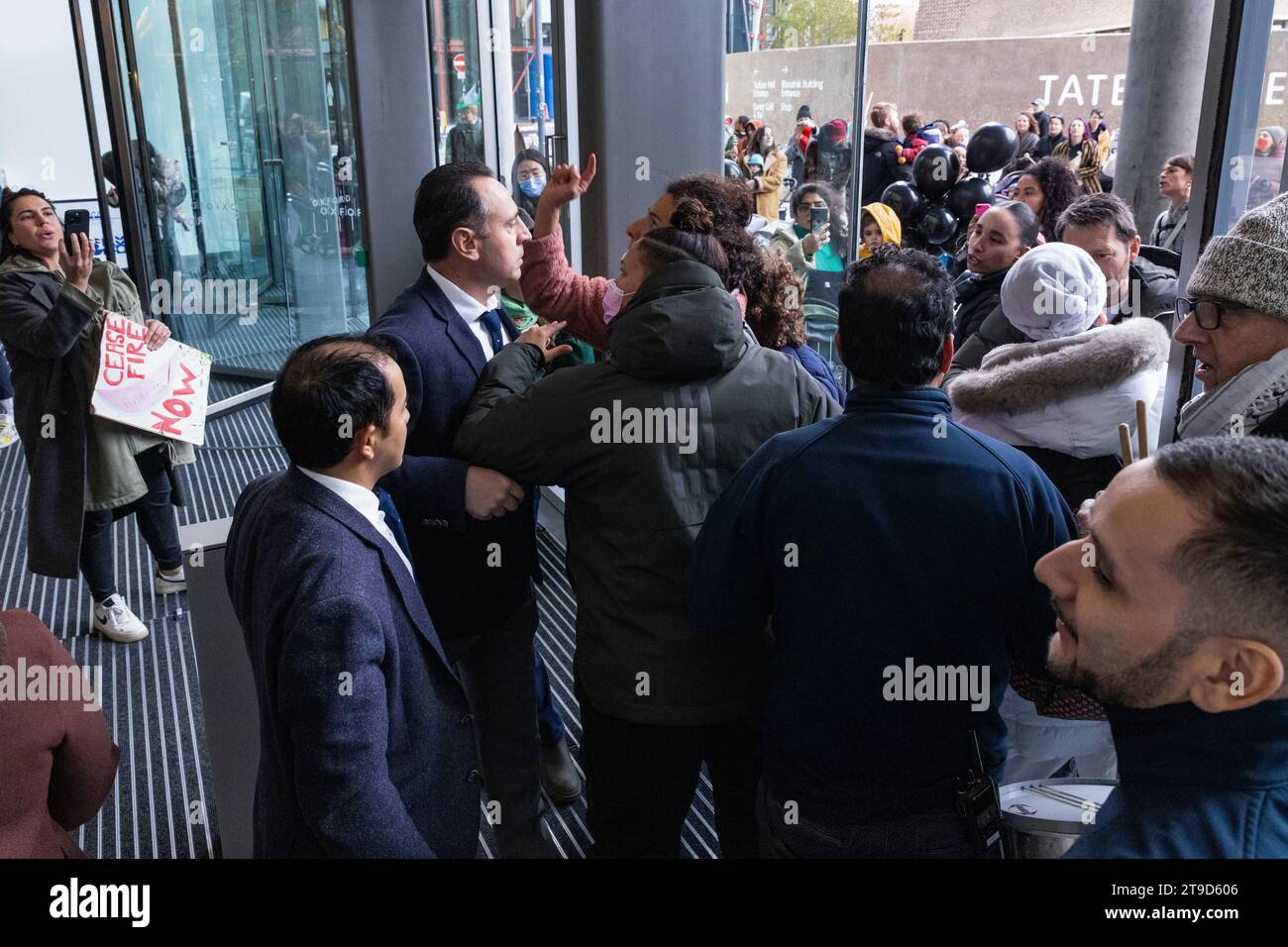 London, UK. 24th November, 2023. Security guards try to prevent ...