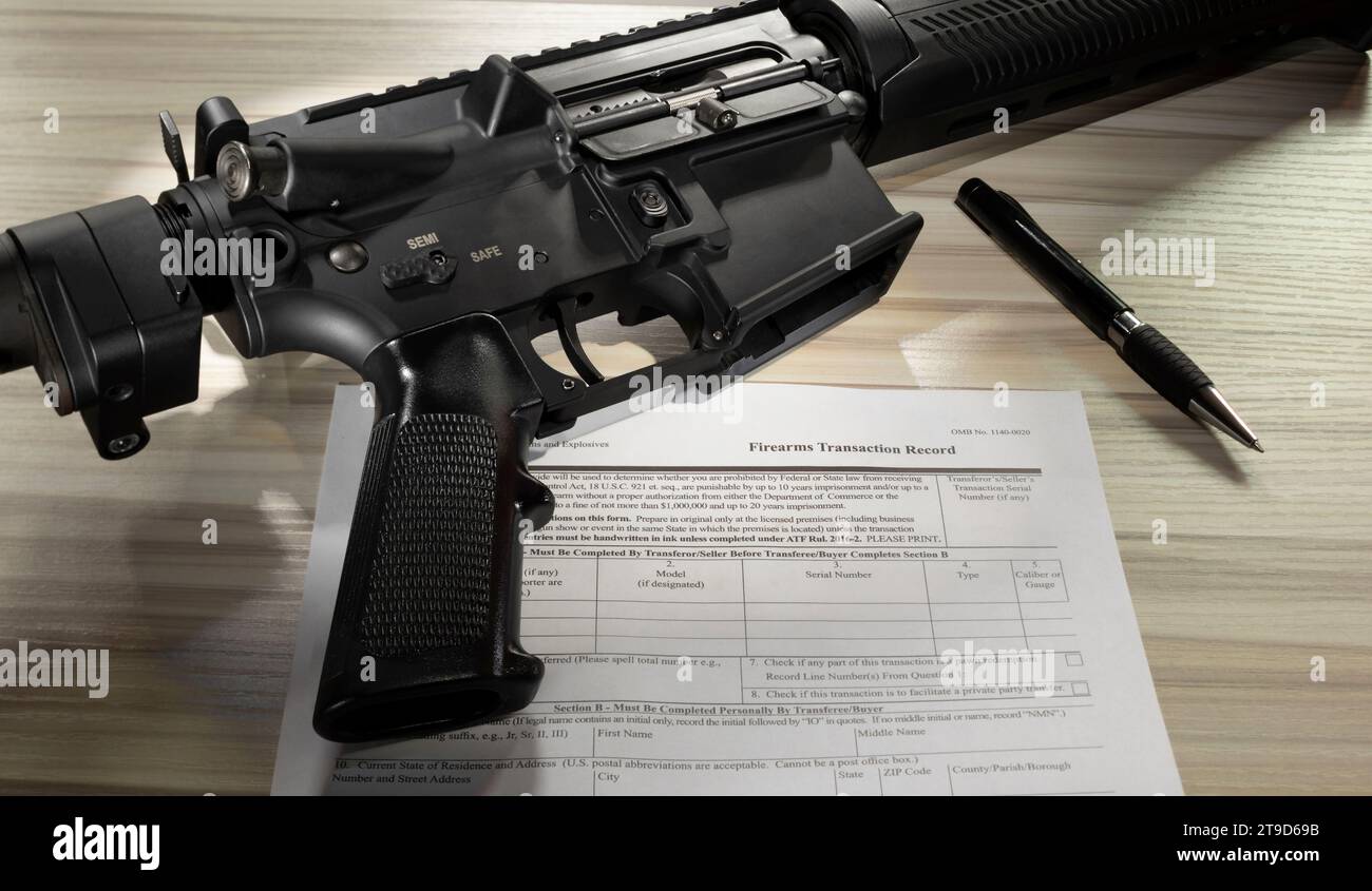 Assault rifle with pen and public domain background check form Stock ...