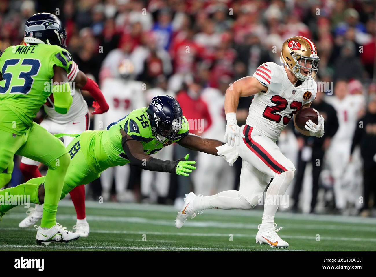 San Francisco 49ers running back Christian McCaffrey (23) escapes a ...