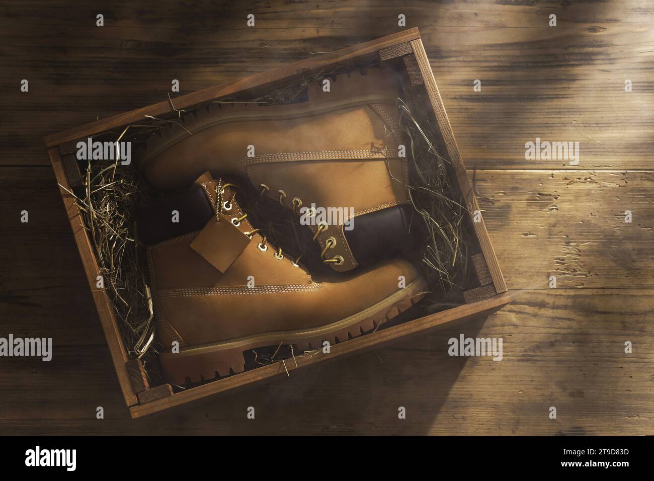 New leather boots inside the wooden box filled with hay Stock Photo - Alamy