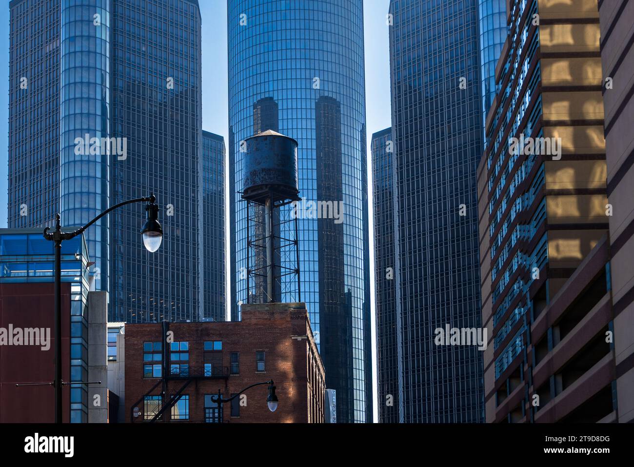Old-fashioned water tower in front of the glass facades of high-rise ...