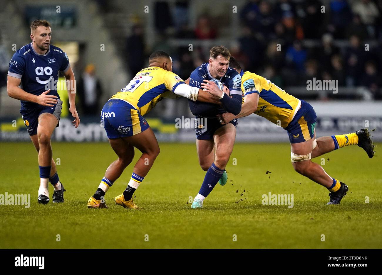 Sale's Tom Roebuck (centre) is tackled by Bath's Max Ojomoh (left) and ...