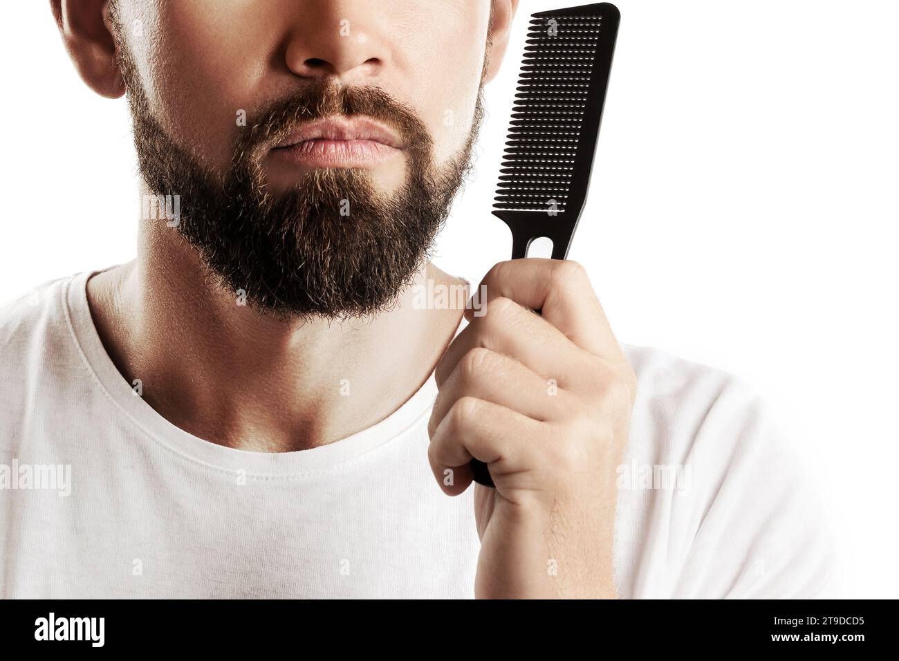 Man combing his thick beard on white background Stock Photo - Alamy