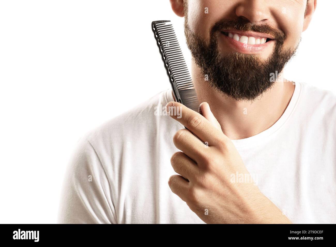 Man combing his thick beard on white background Stock Photo - Alamy