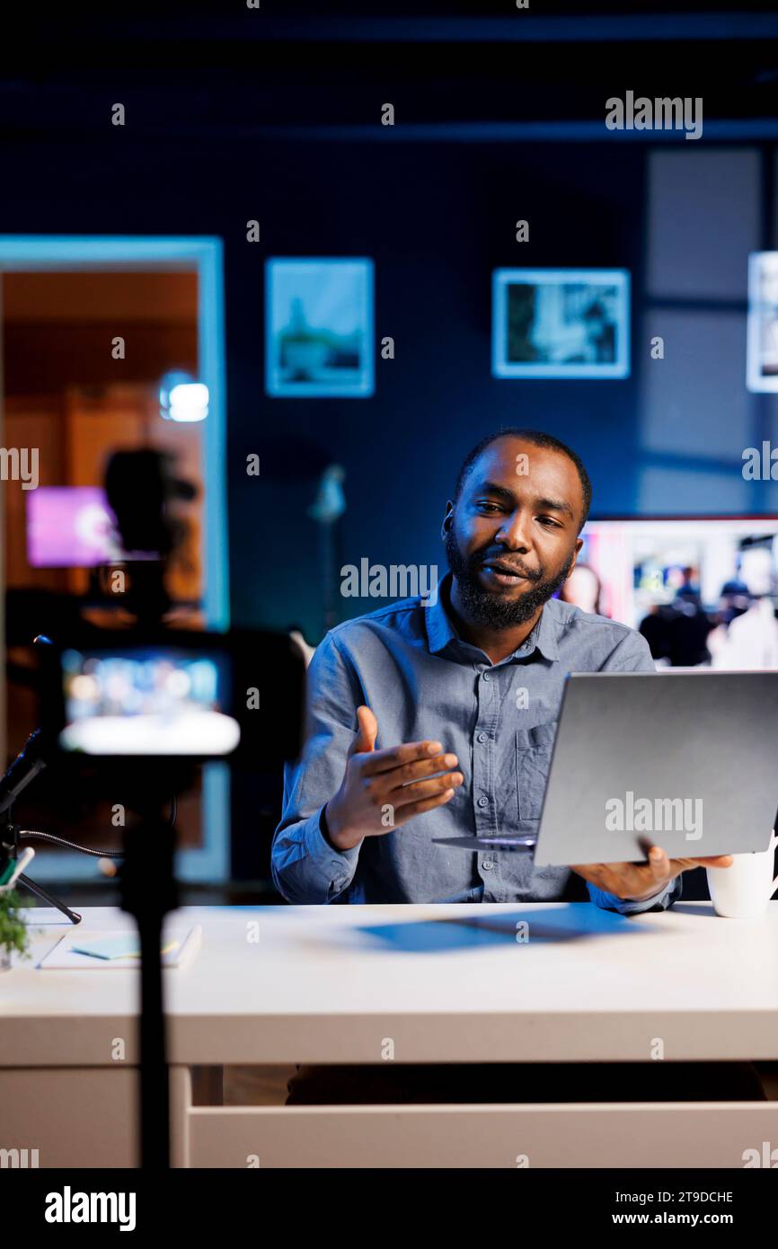 Content creator filming tech tutorial on how to do laptop maintenance ...