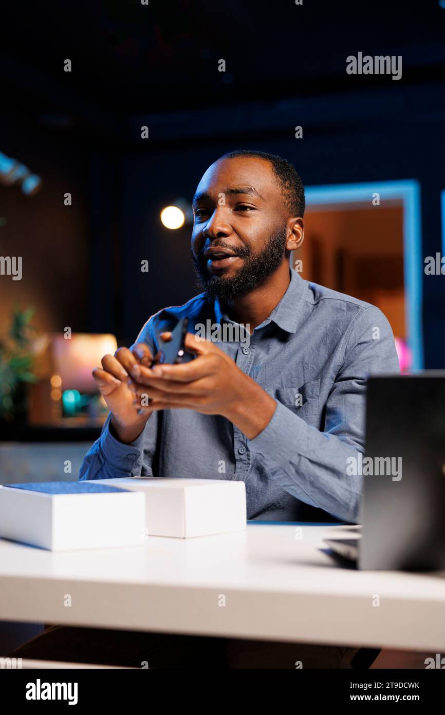 BIPOC tech content creator filming technology review of newly released ...