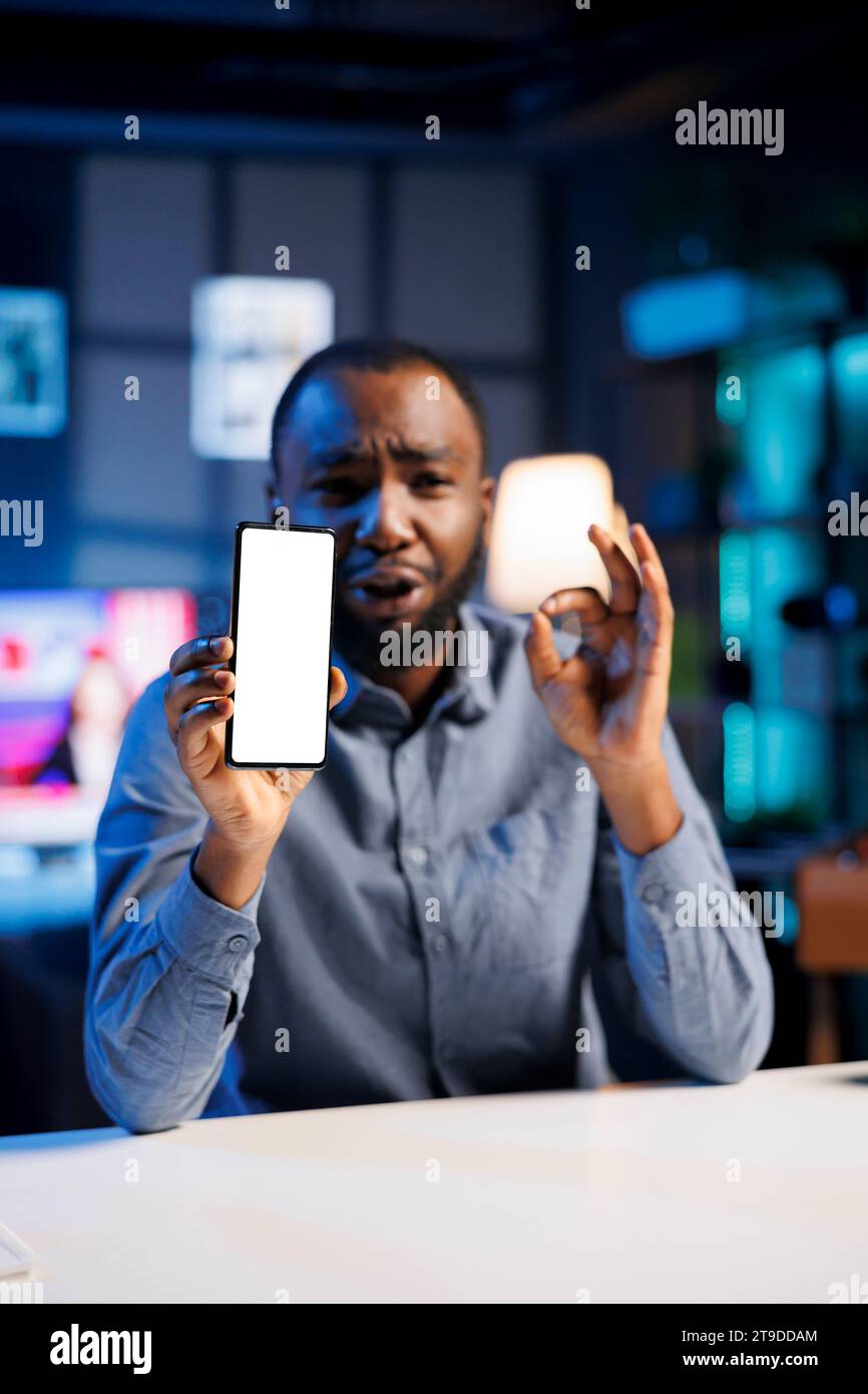 Media star doing review of mockup smartphone, comparing features to ...