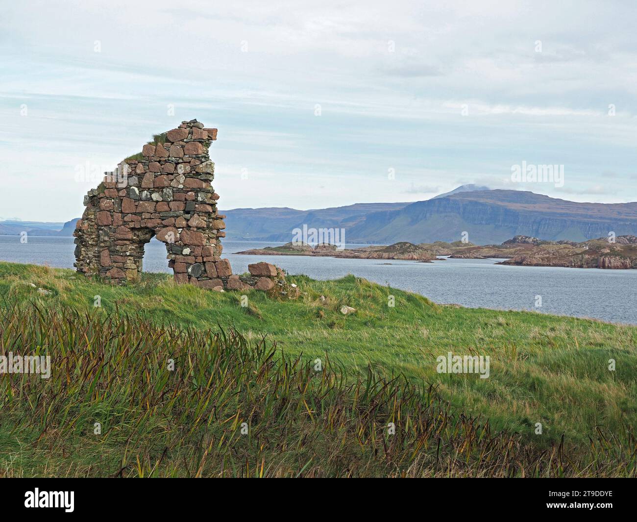 view past a ruined stone building from the northern coast of the ...