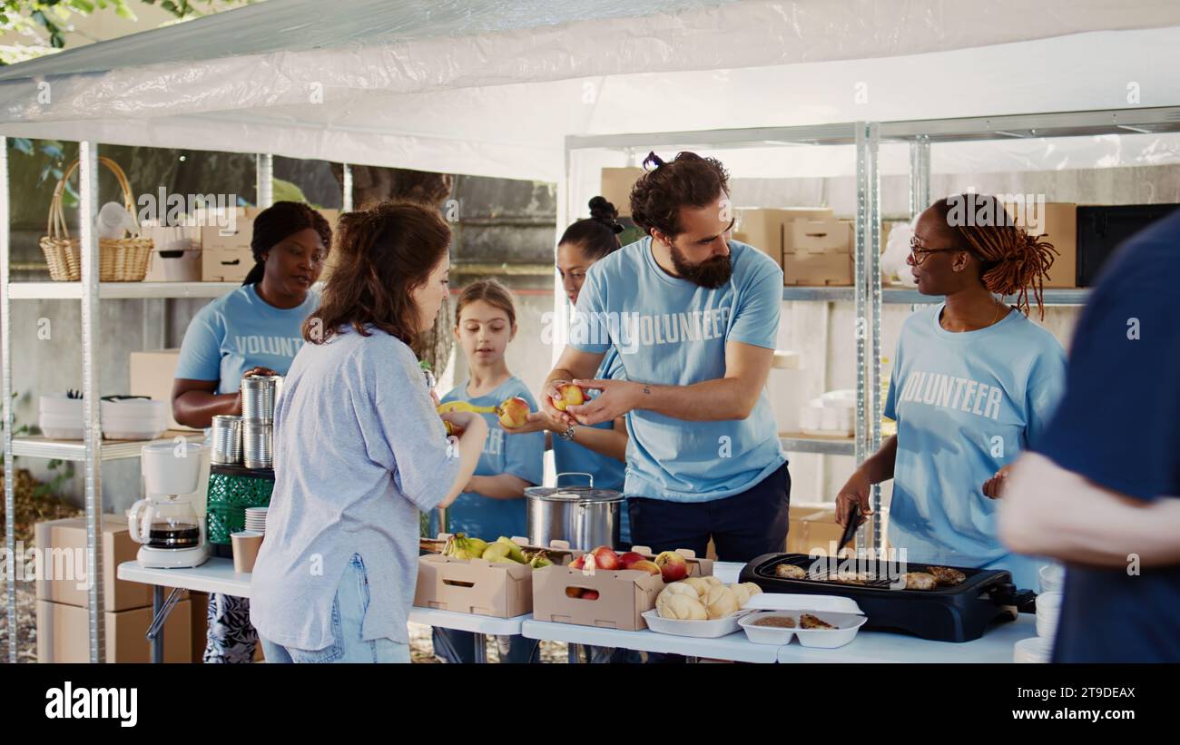 Volunteer in blue shirts feeding hi-res stock photography and images ...