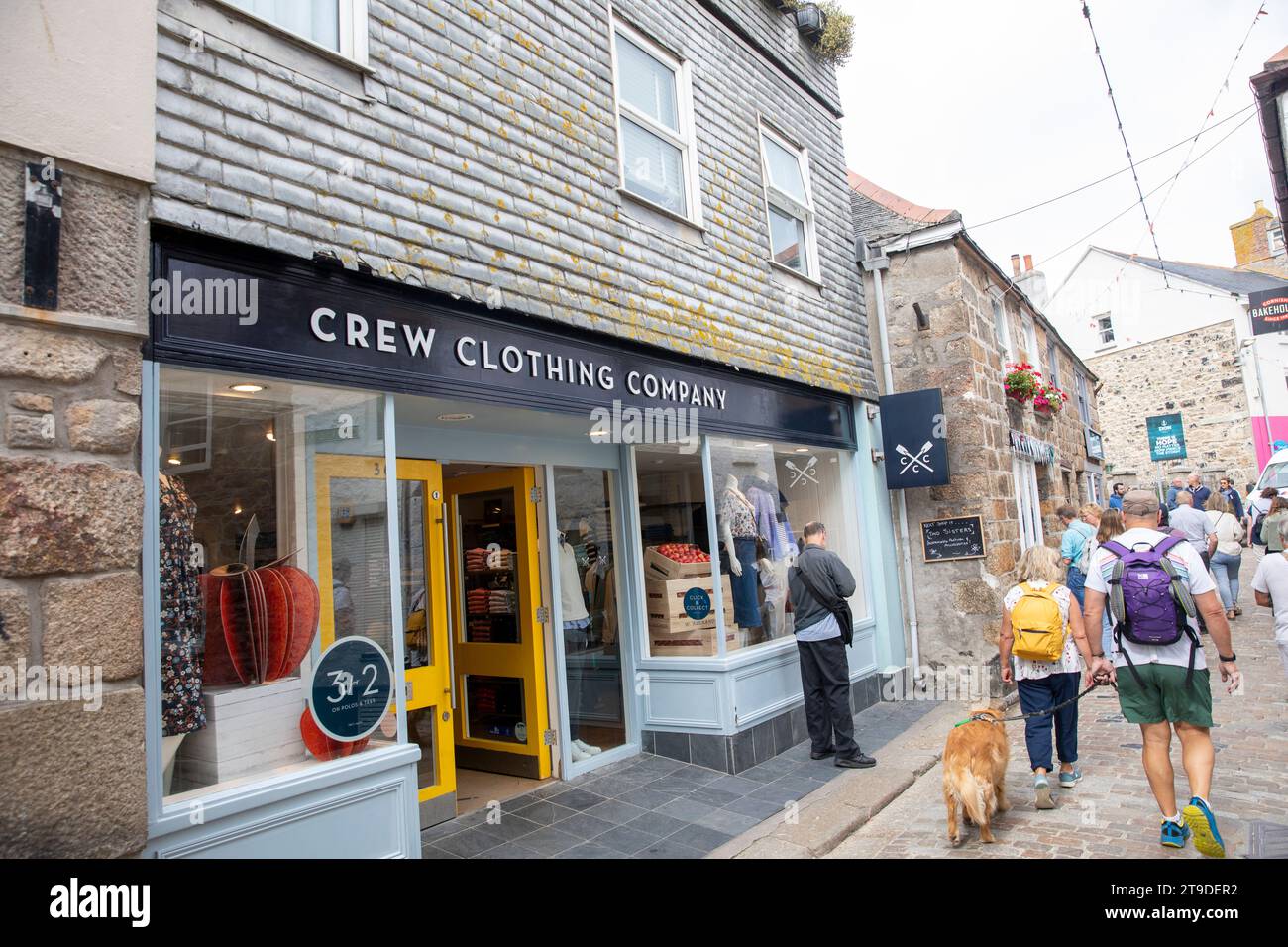 Shoppers in St Ives town centre walking past Crew Clothing store ...