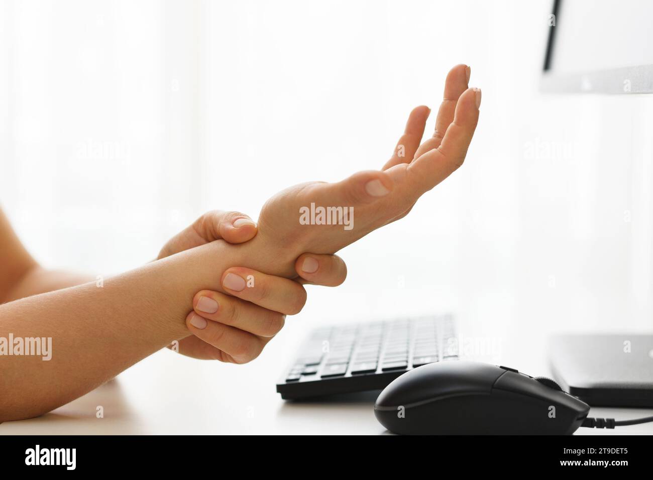 Closeup of female hands with a pain in the wrist because of carpal ...