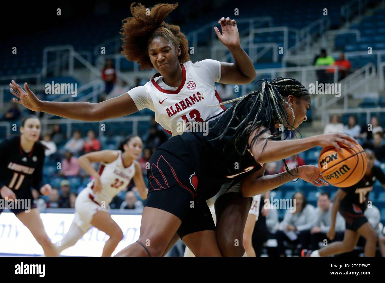 Louisville forward Nyla Harris, front, drives around Alabama center ...
